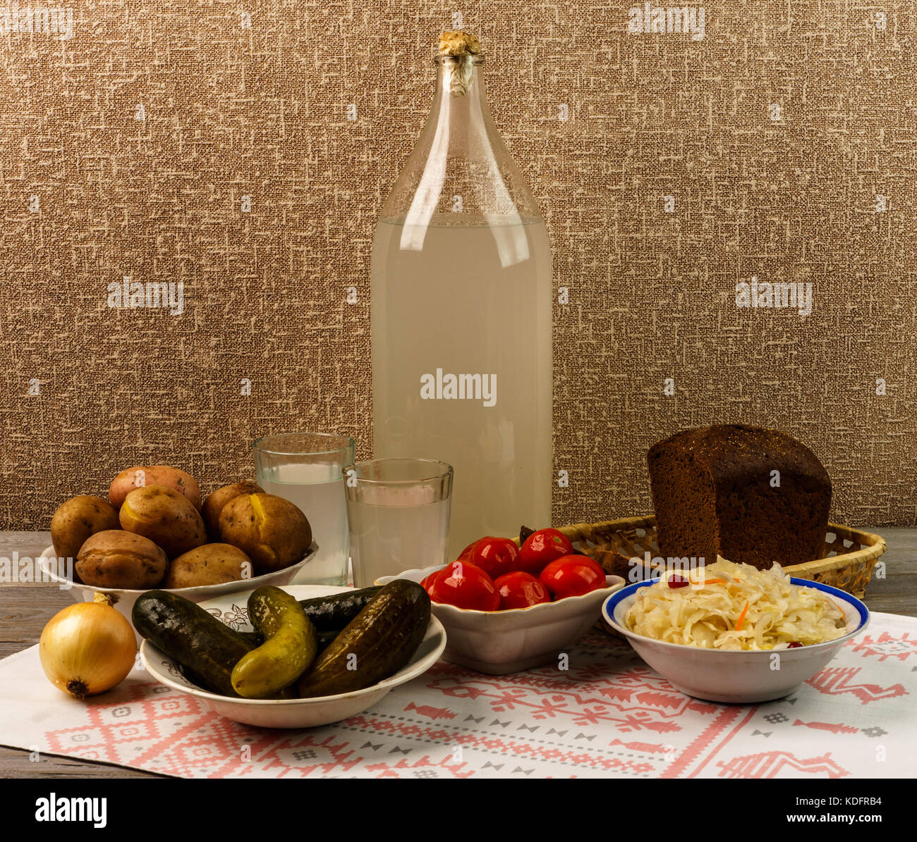 Ukrainian national drink and snack. The bottle and glass of moonshine ...