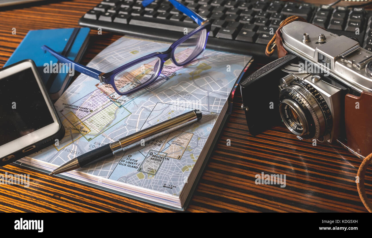 tourist's travel tools with retro style camera Stock Photo - Alamy