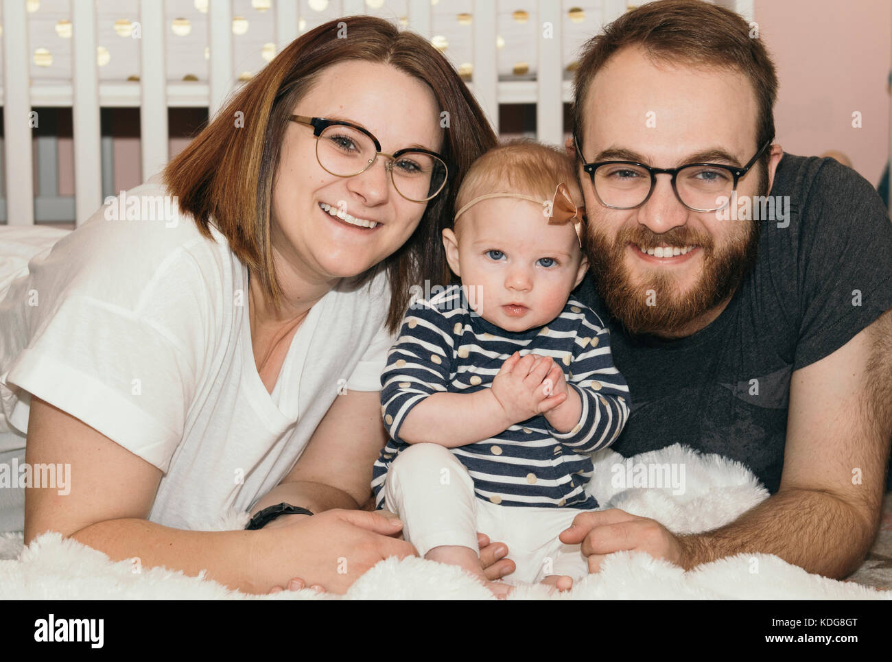 Millennial Family with Mom, Dad, and Beautiful Baby Girl Stock Photo ...