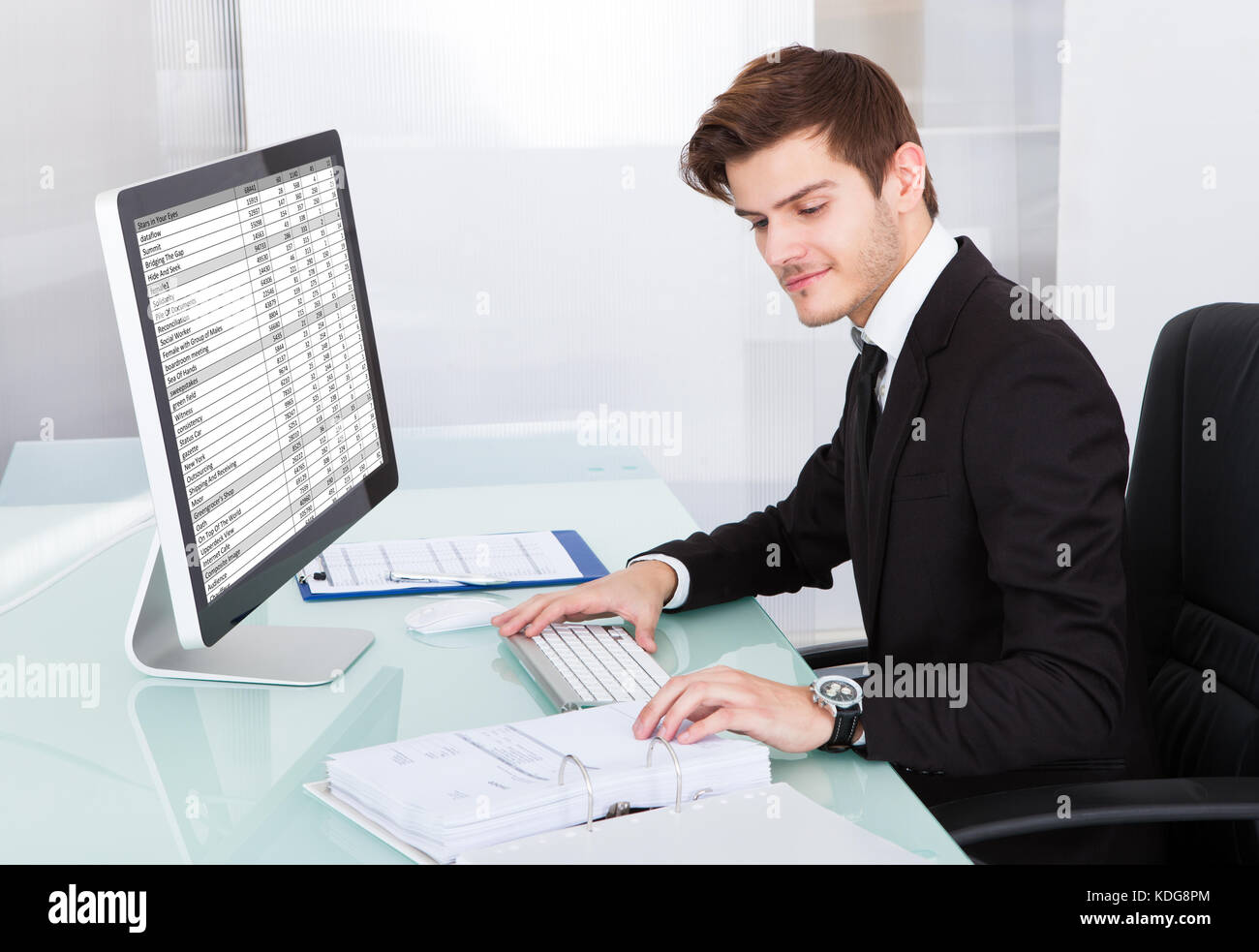 Portrait Of Young Businessman Using On Computer At Desk Stock Photo - Alamy
