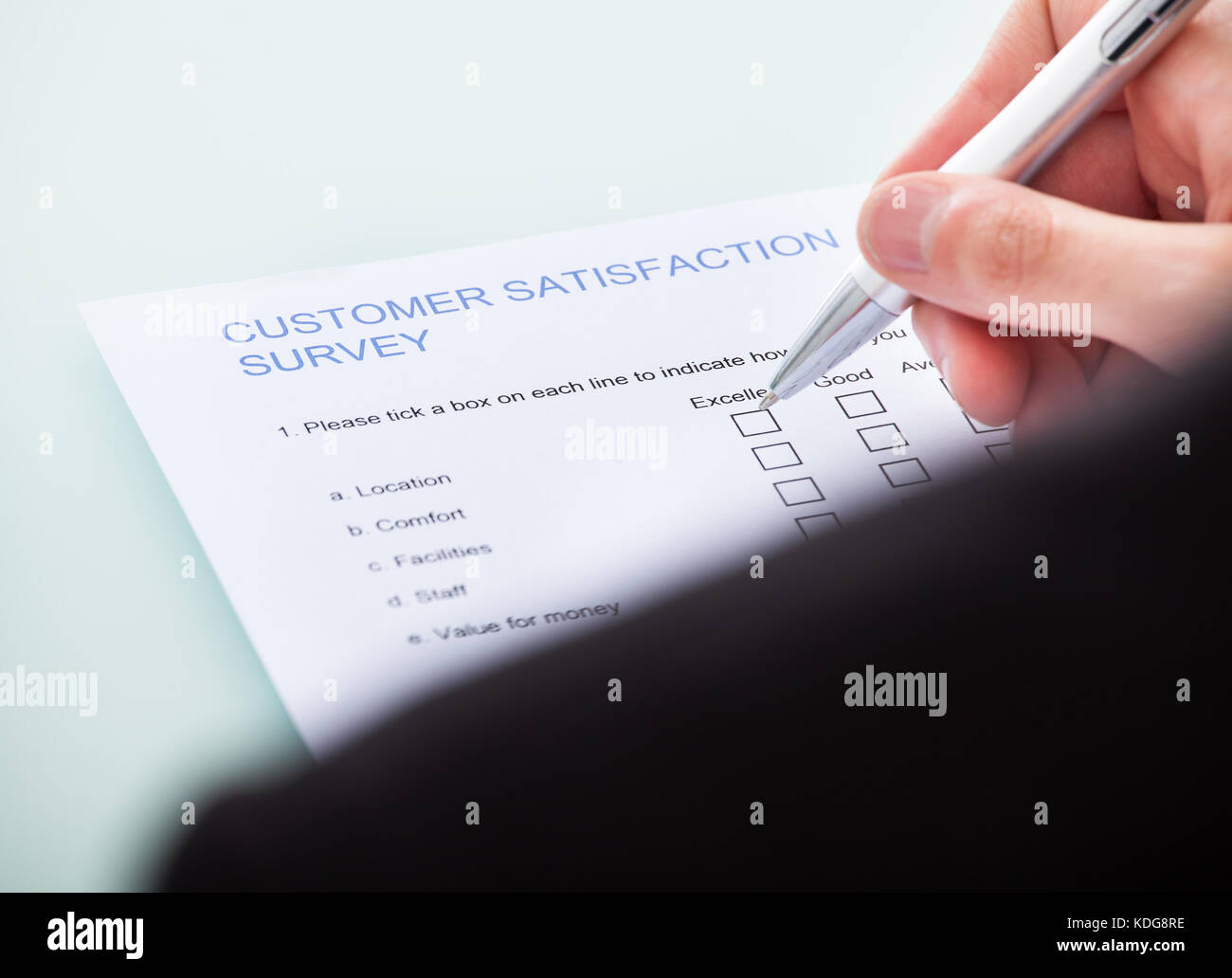 Close-up Of Man's Hand Filling Customer Survey Form Stock Photo - Alamy