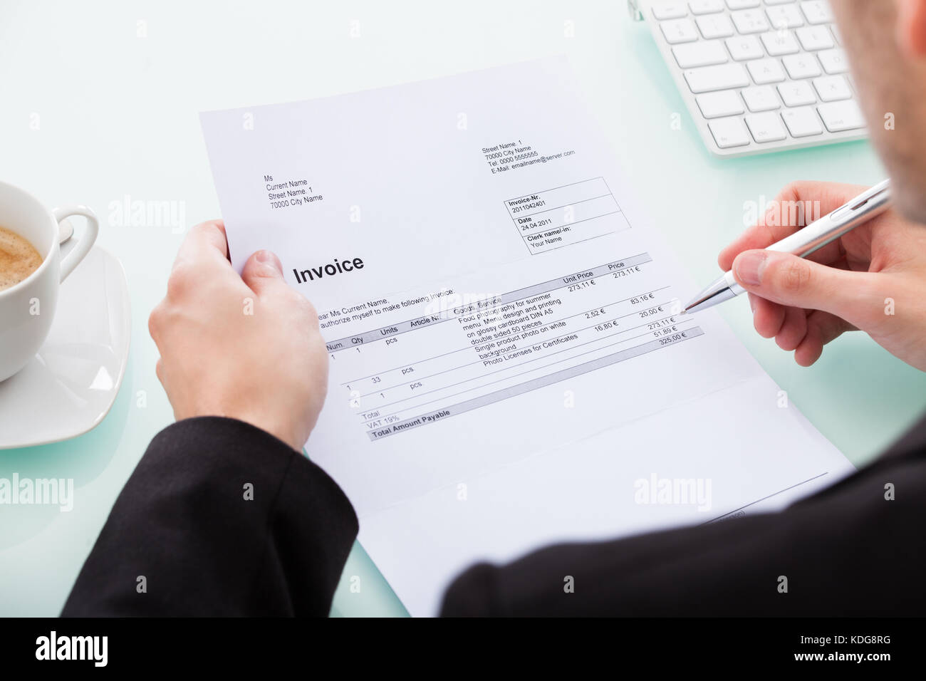 Close-up Of A Businessman At Desk Holding Invoice And Pen Stock Photo ...