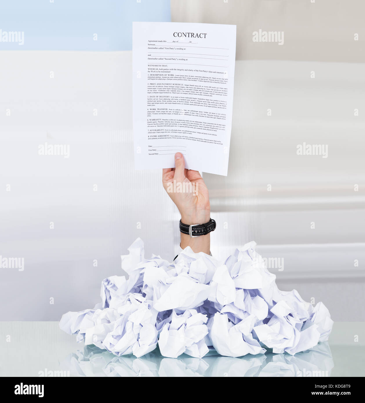 Person Under Pile Of Crumpled Paper Holding Contract Paper Stock Photo ...