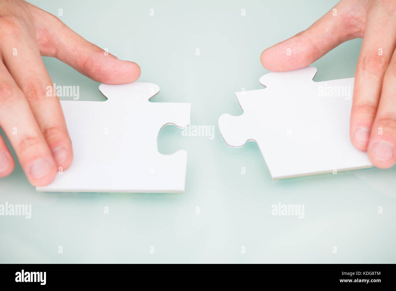 Close-up Of A Businessman Solving Jigsaw Puzzle In Office Stock Photo ...