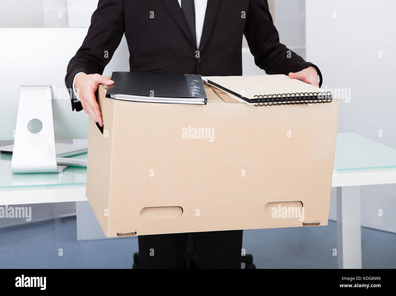 Close-up Of A Businessman Carrying Box At His Workplace Stock Photo - Alamy