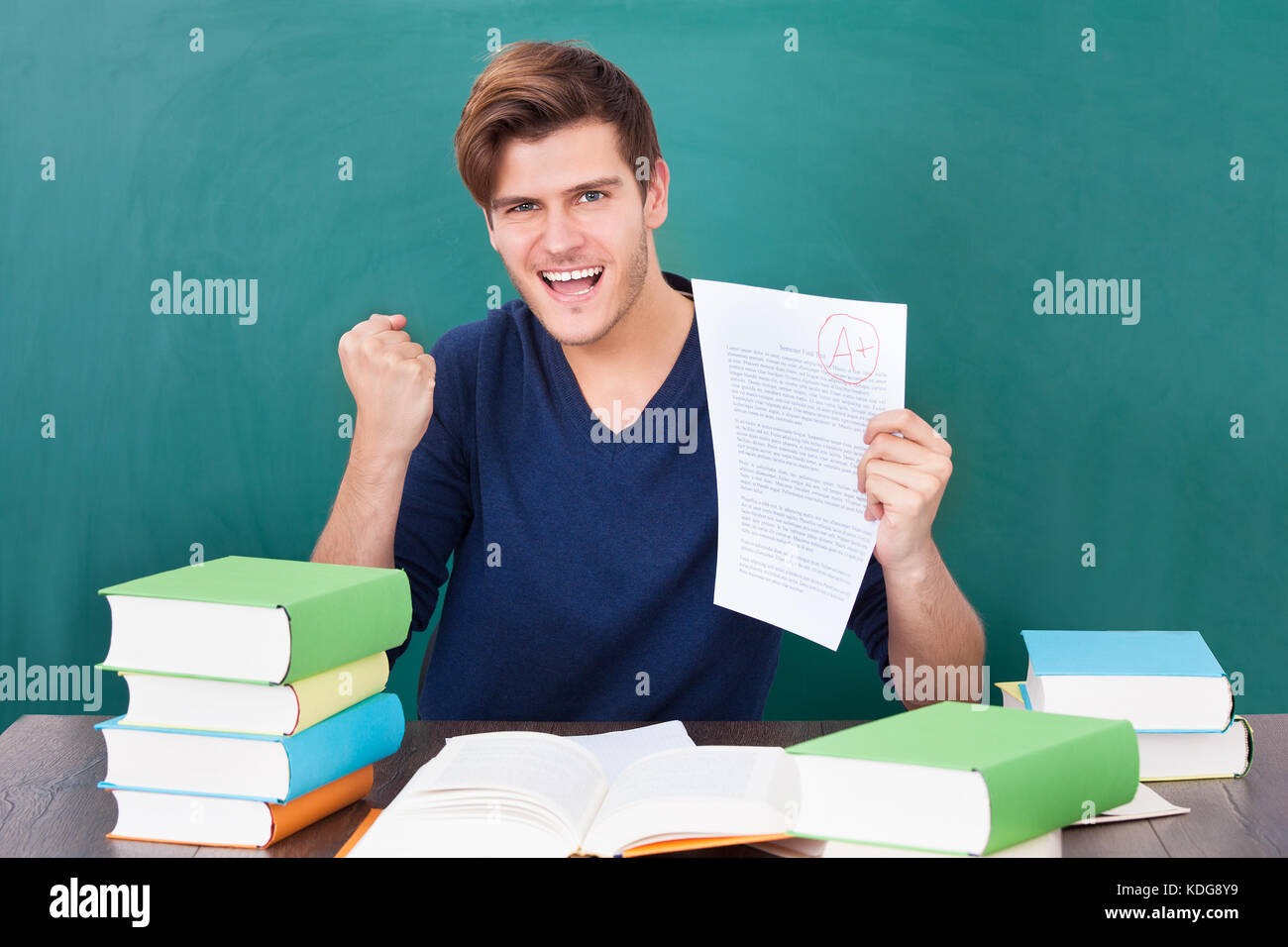 Portrait Of A Successful Student Holding Examination Paper Stock Photo ...