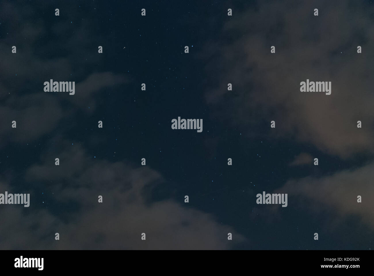 Visible meteor trace on starry and cloudy night sky - Perseids meteor ...