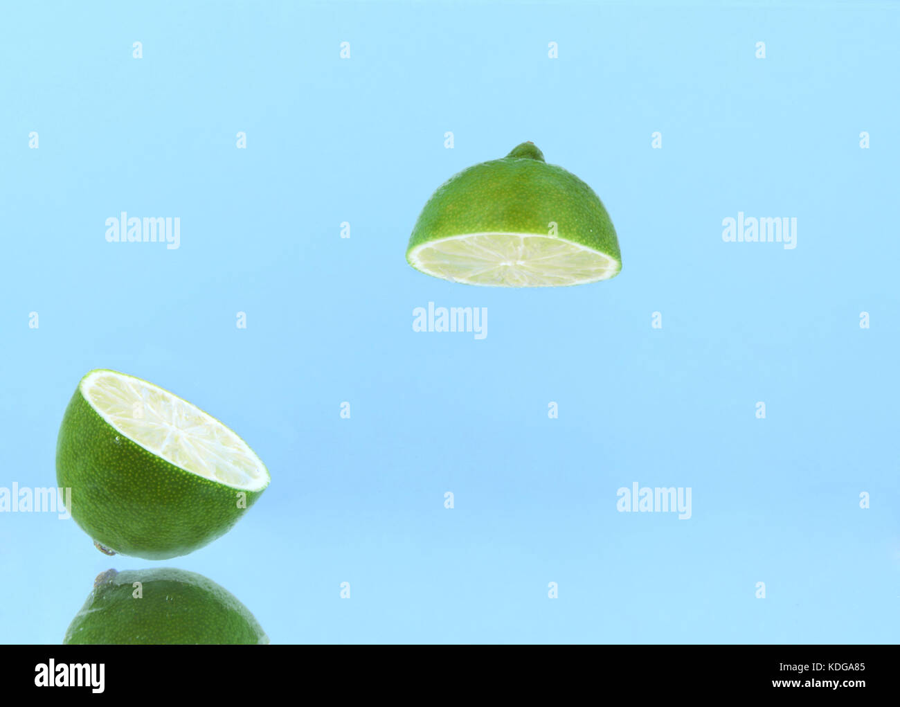 Juicy slices of lime on trendy blue background. Place for your text ...