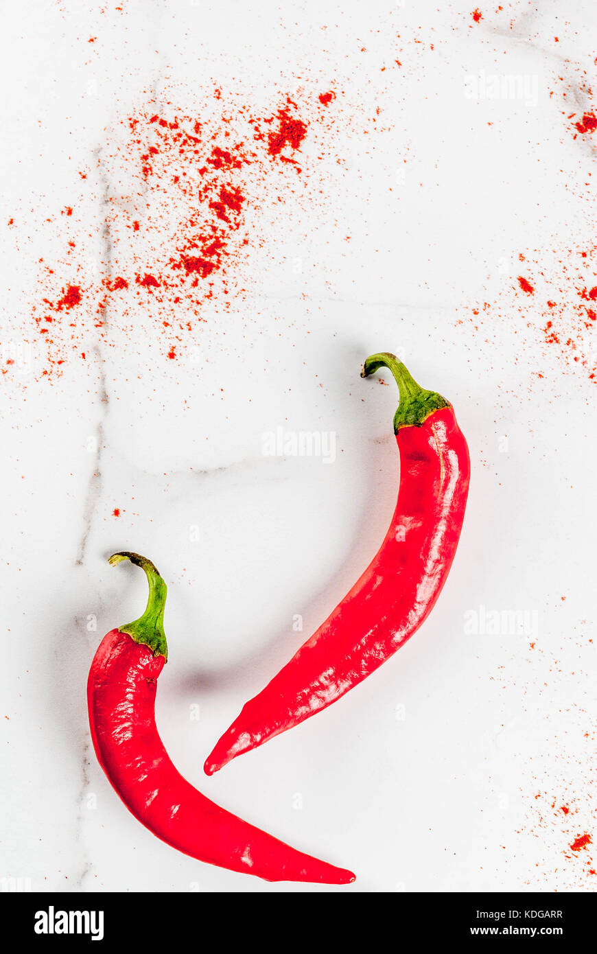 Raw fresh organic and dried ground chili pepper on white marble ...