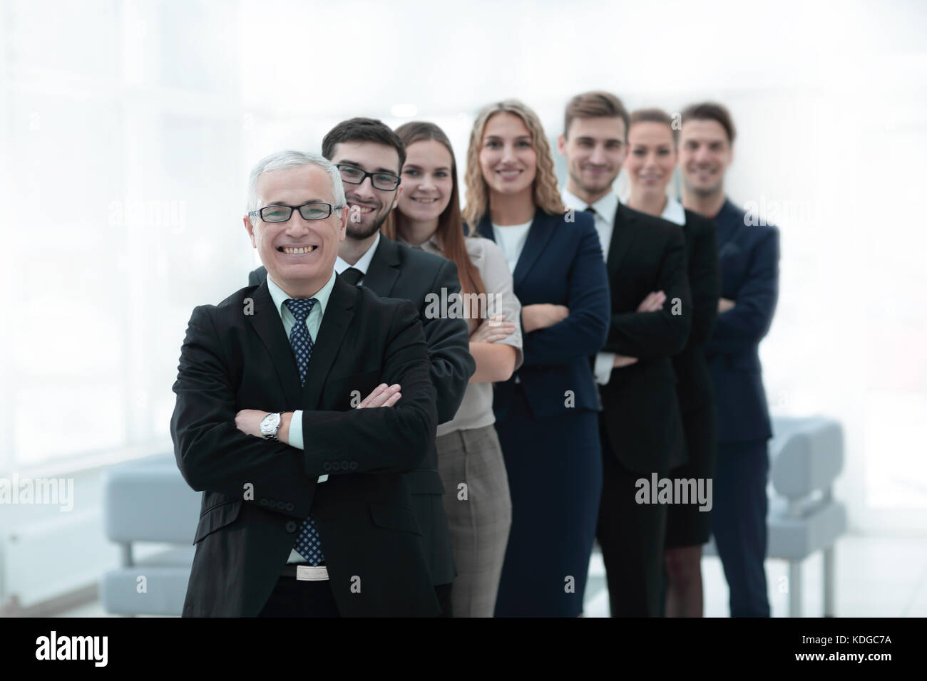 senior businessman standing in front of his business team Stock Photo ...