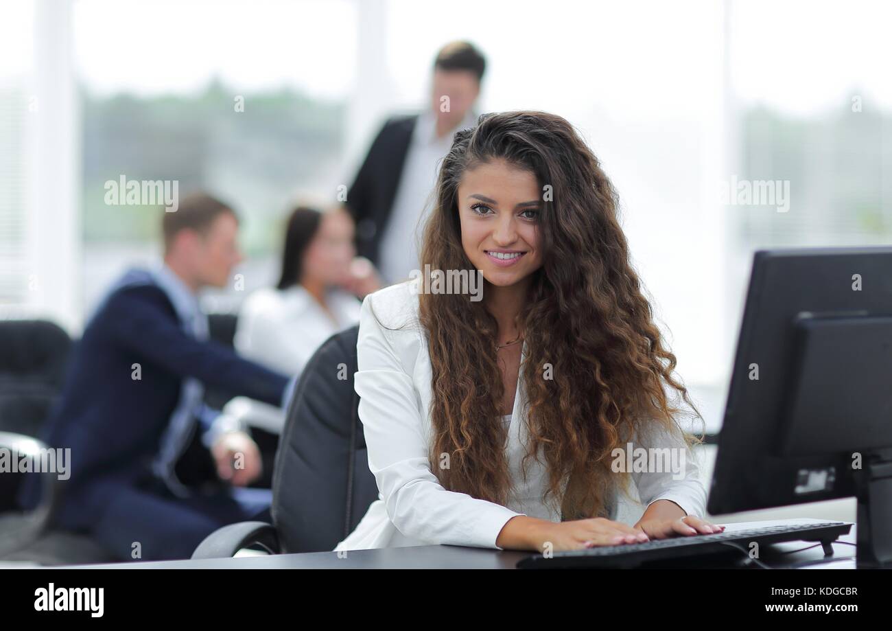 Manager woman sitting behind a Desk Stock Photo - Alamy