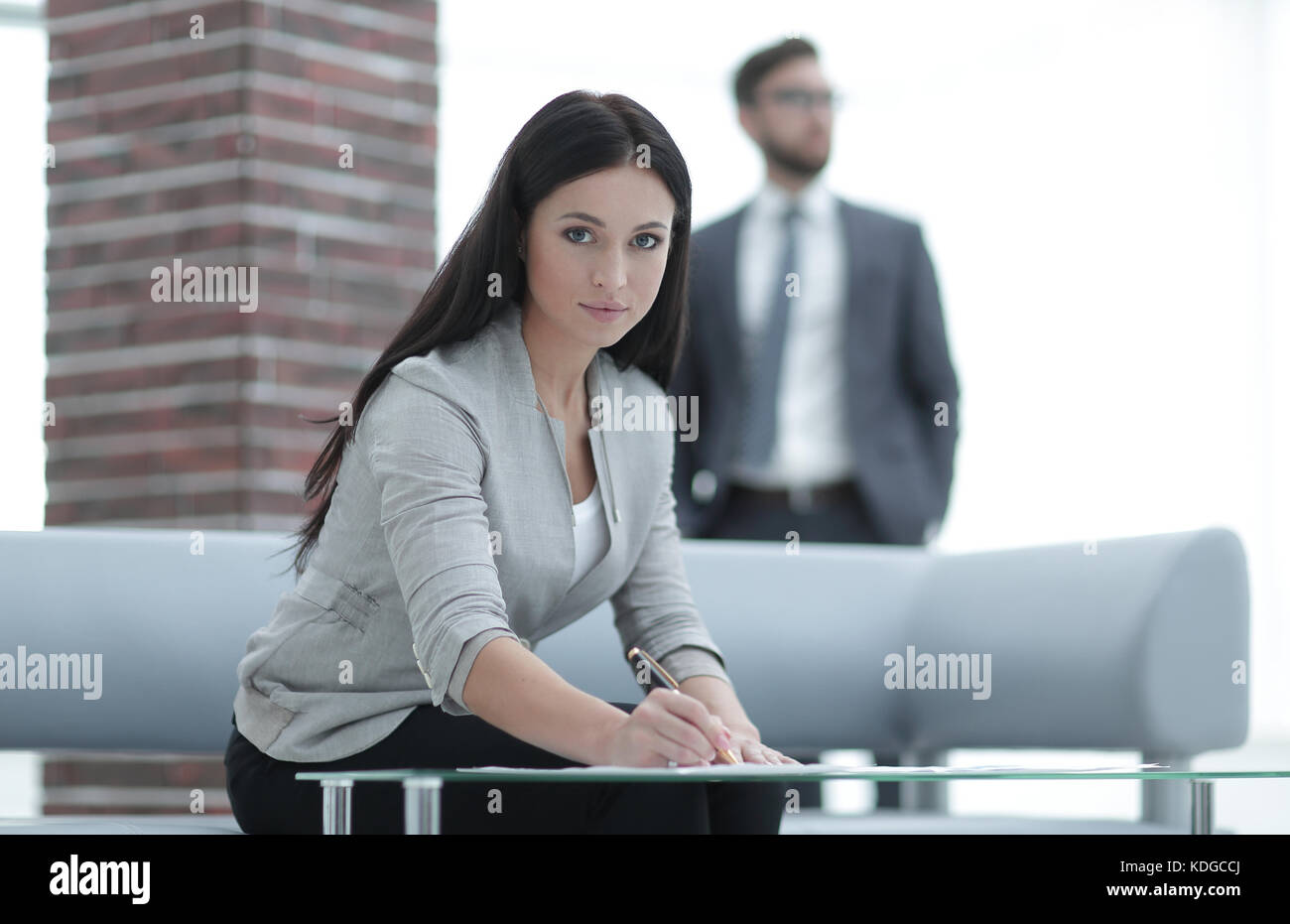 business woman signs documents in a modern office Stock Photo - Alamy