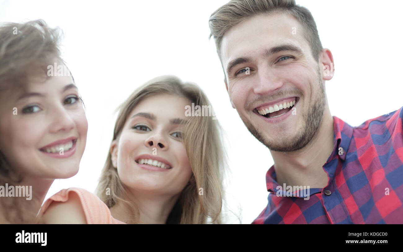 closeup of three young people smiling on white background Stock Photo ...