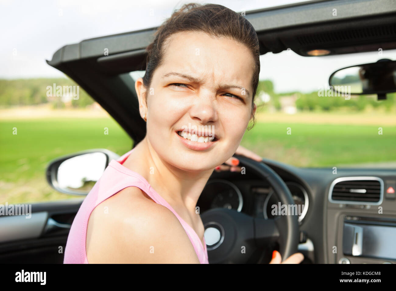 Young Woman Looking Back While Travelling In Car Stock Photo - Alamy