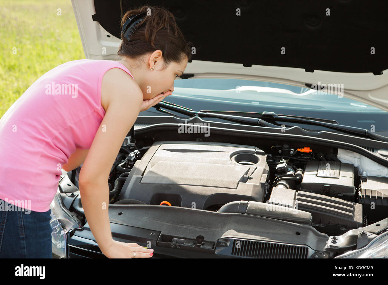 Woman looking under hood car hi-res stock photography and images - Alamy