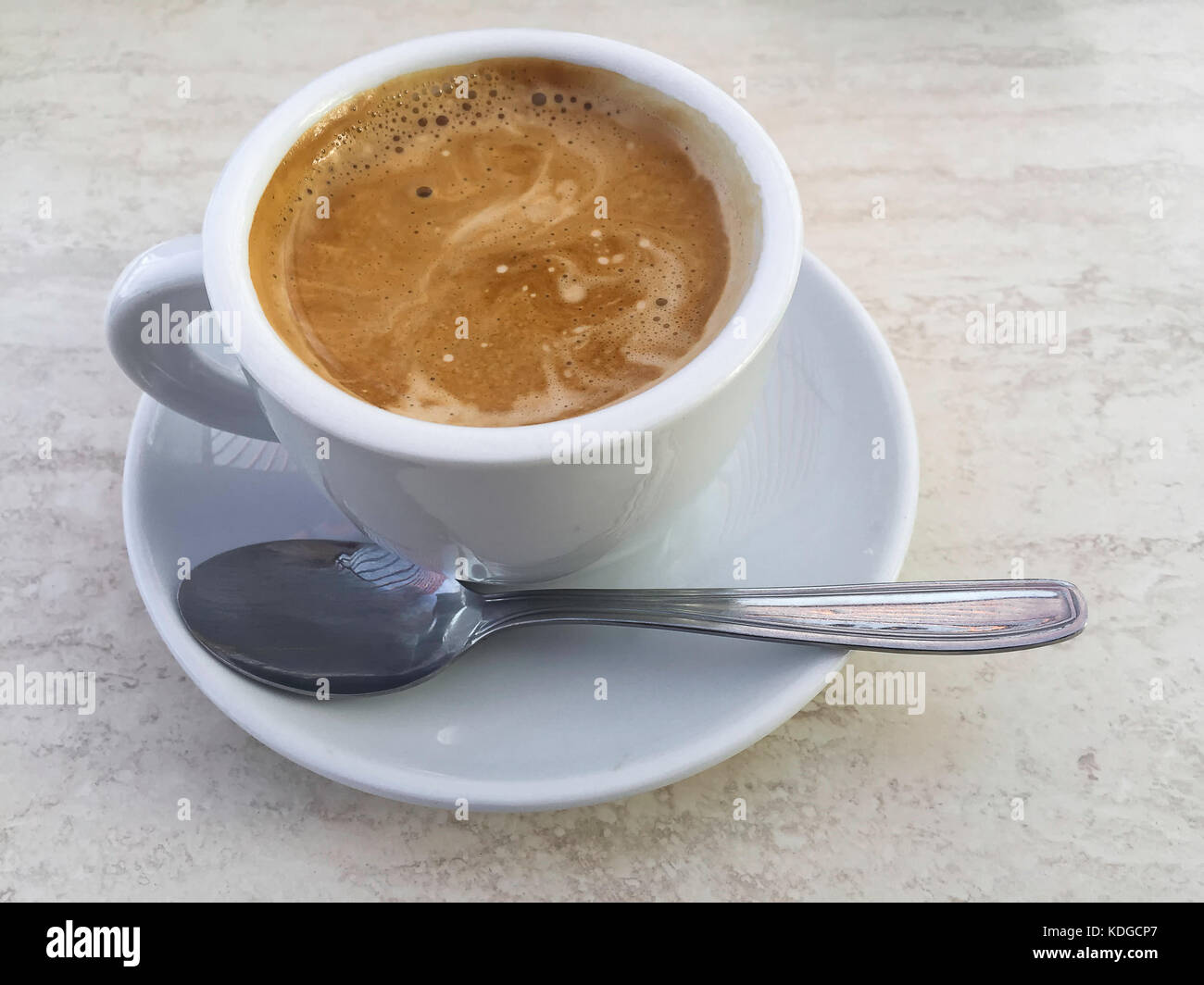 A double shot cup of cappuchino in a white cup Stock Photo - Alamy
