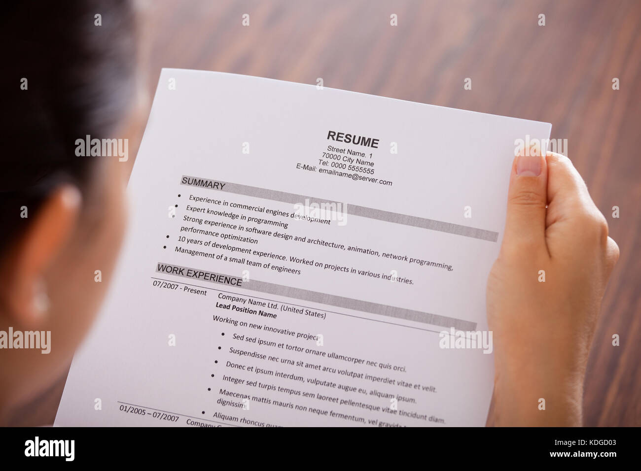 Close-up Of Young Businesswoman Reading Resume At Desk Stock Photo - Alamy
