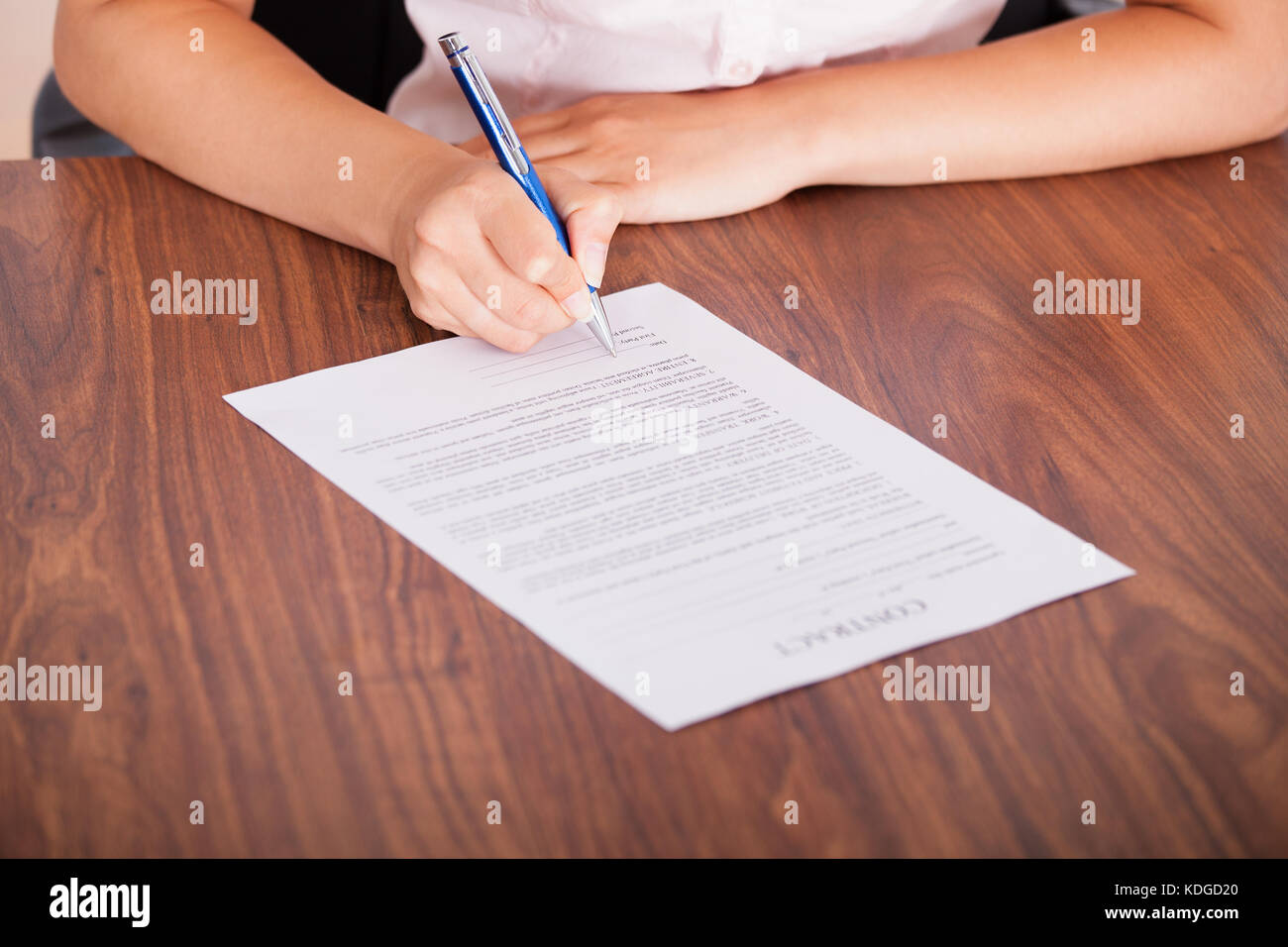Professional Woman Signing Document At Desk Stock Photos & Professional ...