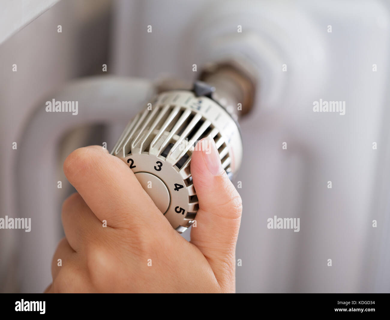 Woman Hand Adjusting The Temperature By Thermostat Stock Photo - Alamy