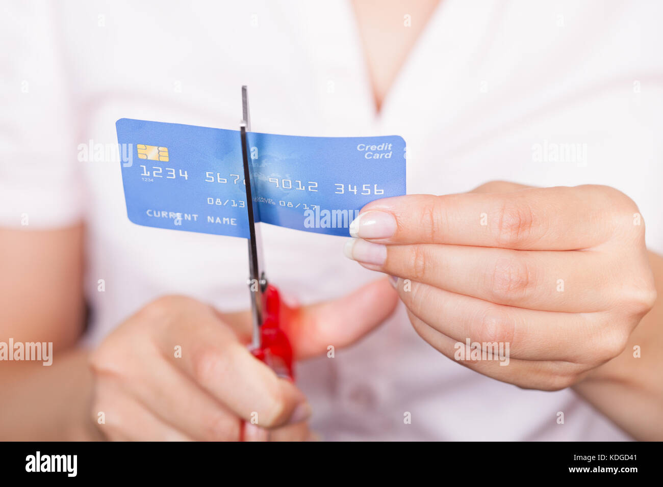Close-up Of Female Hand Cutting Credit Card With Scissor Stock Photo ...
