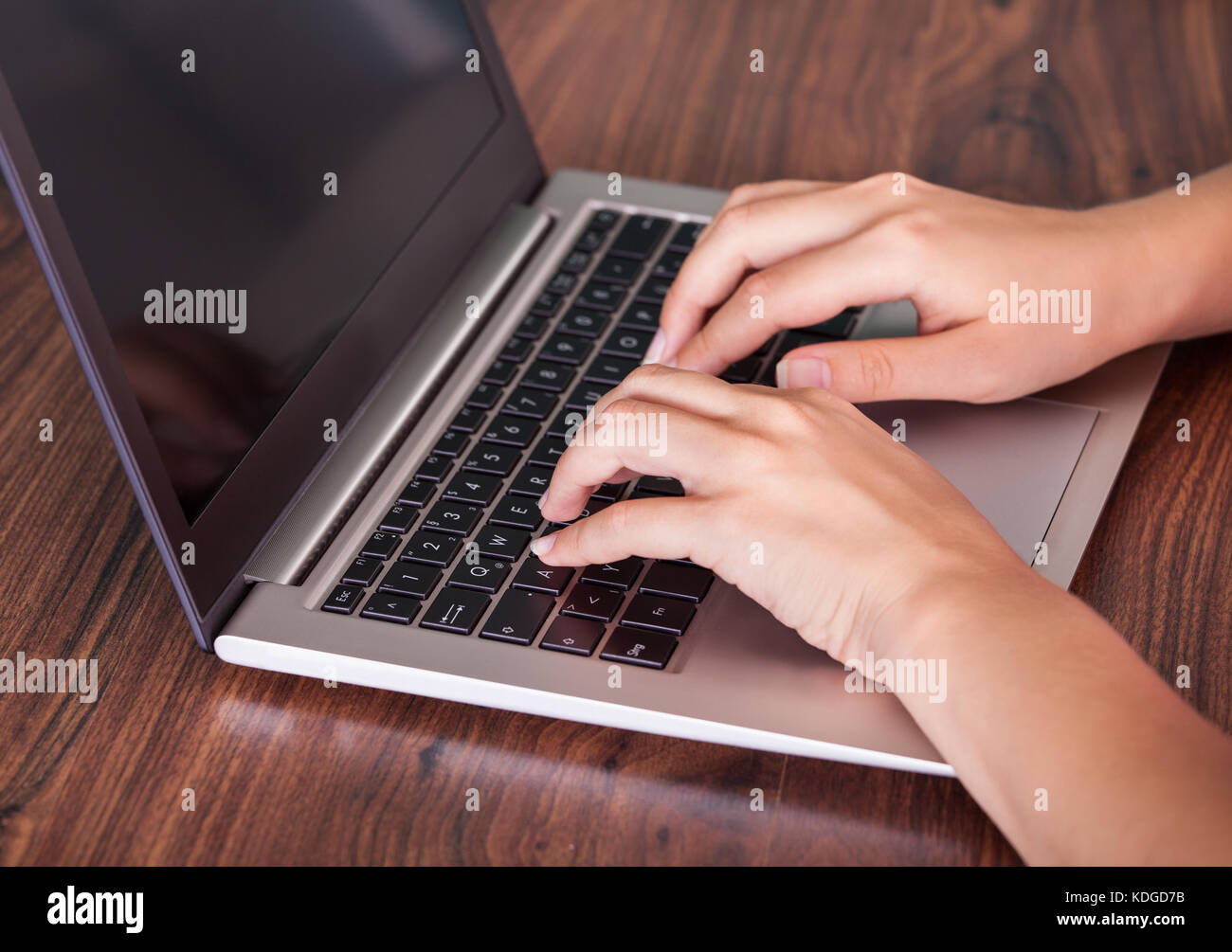 Close-up of human hand using laptop on desk Stock Photo - Alamy