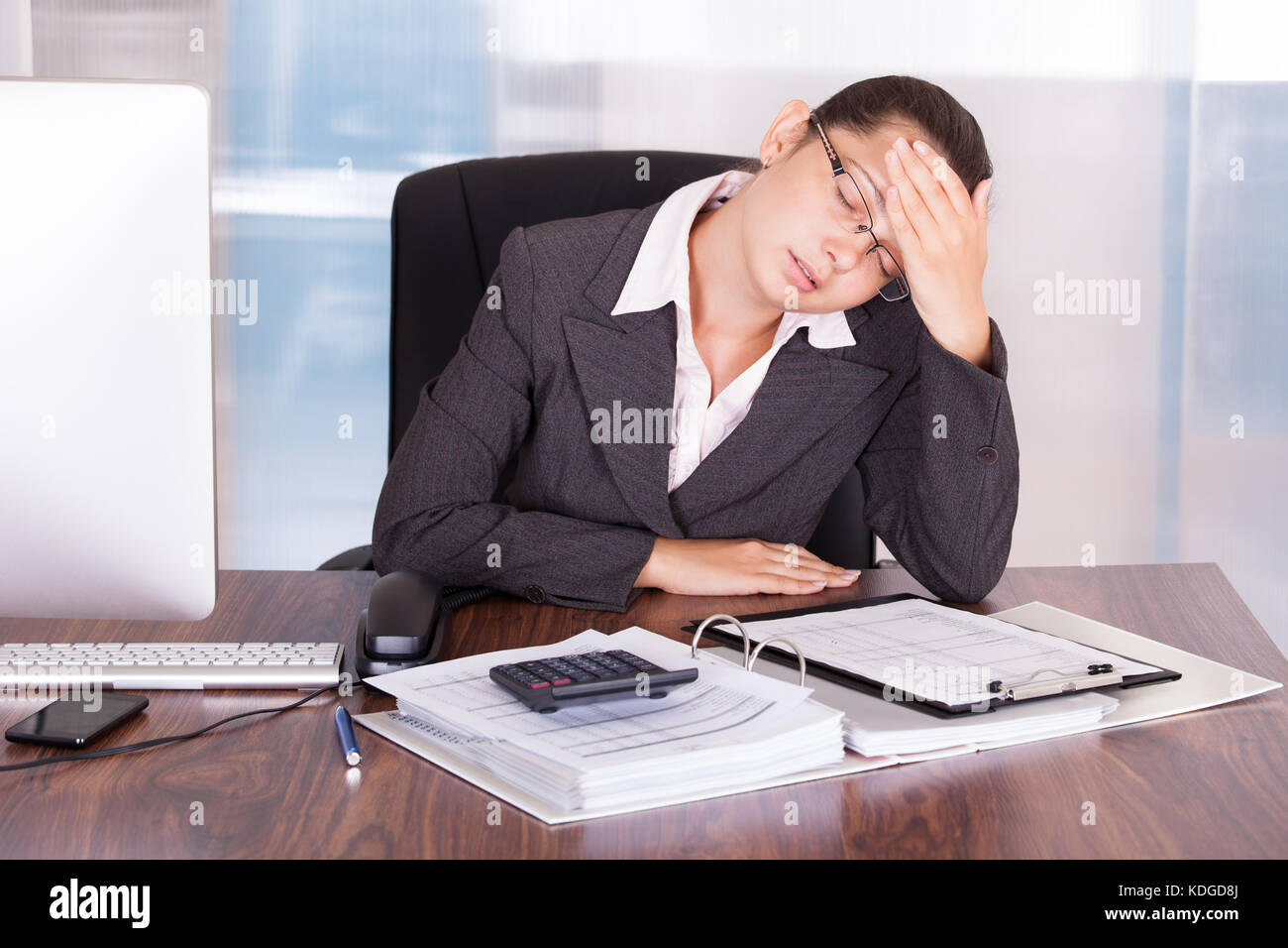 Young Businesswoman Suffering From Headache At Office Stock Photo - Alamy