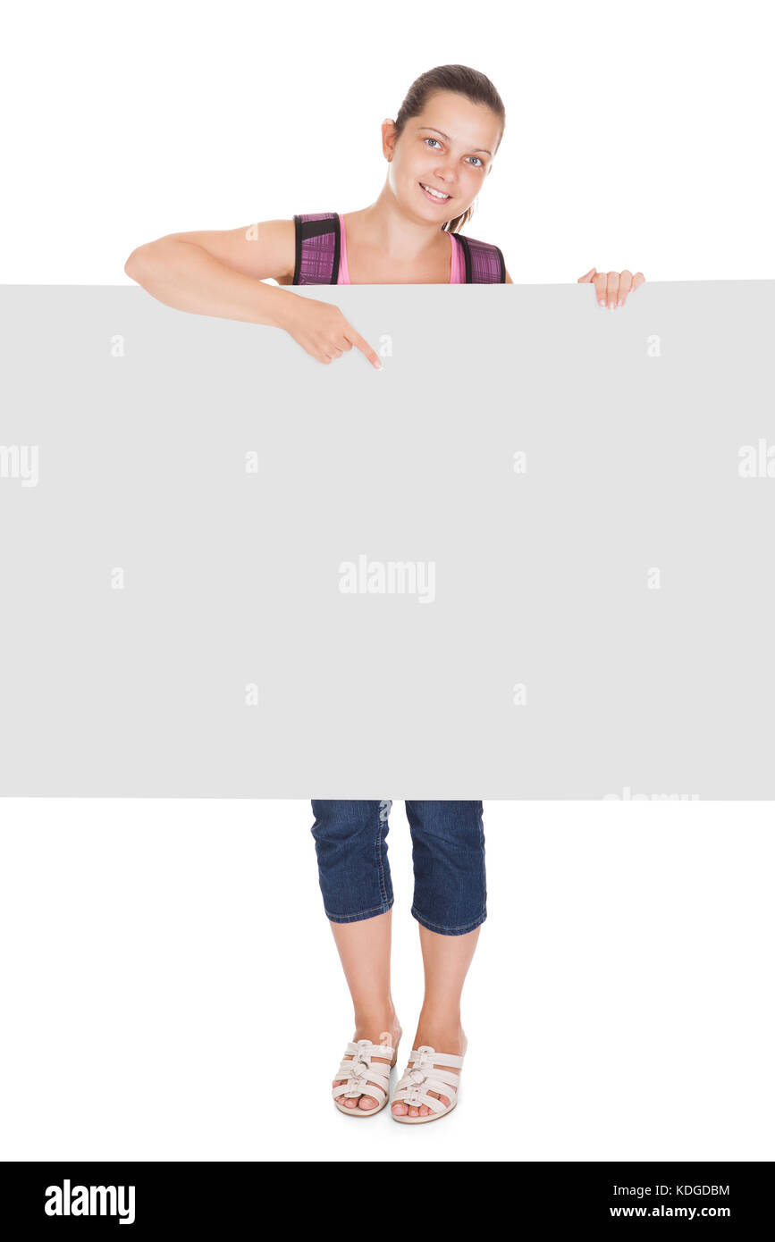 Young female student pointing on placard over white background Stock ...