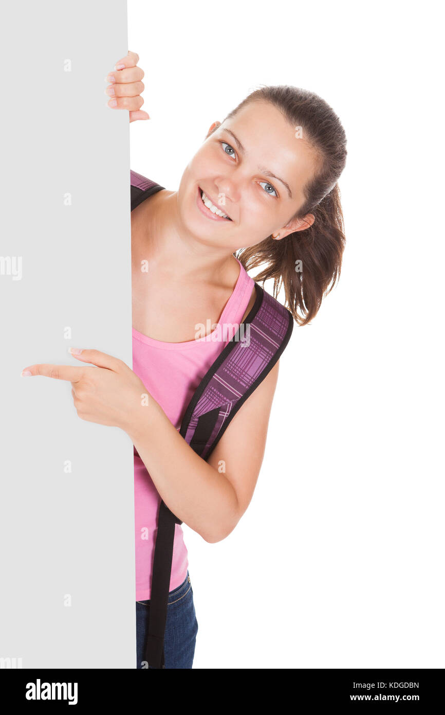 Young female student pointing on placard over white background Stock ...