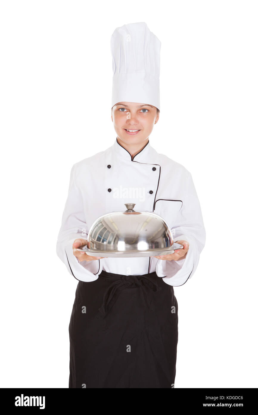 Portrait Of Female Chef holding serving tray on white background Stock ...