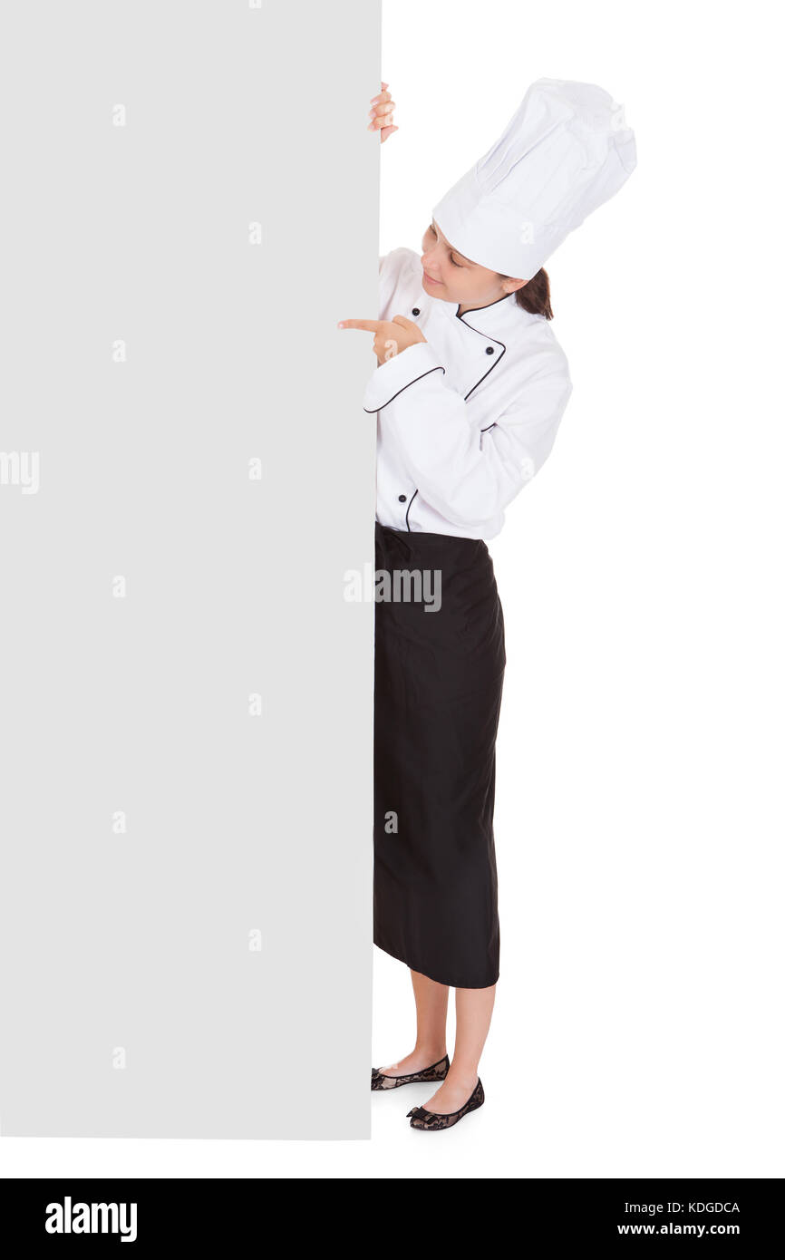 Female chef pointing on blank placard over white background Stock Photo ...