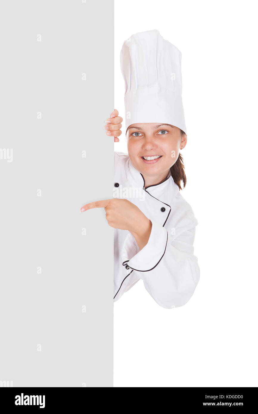 Female chef pointing on blank placard over white background Stock Photo ...
