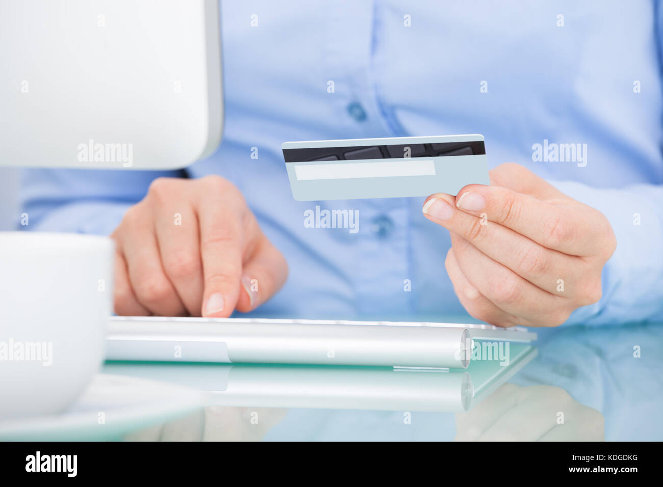Close-up Of A Person Holding Credit Card Using Computer Stock Photo - Alamy