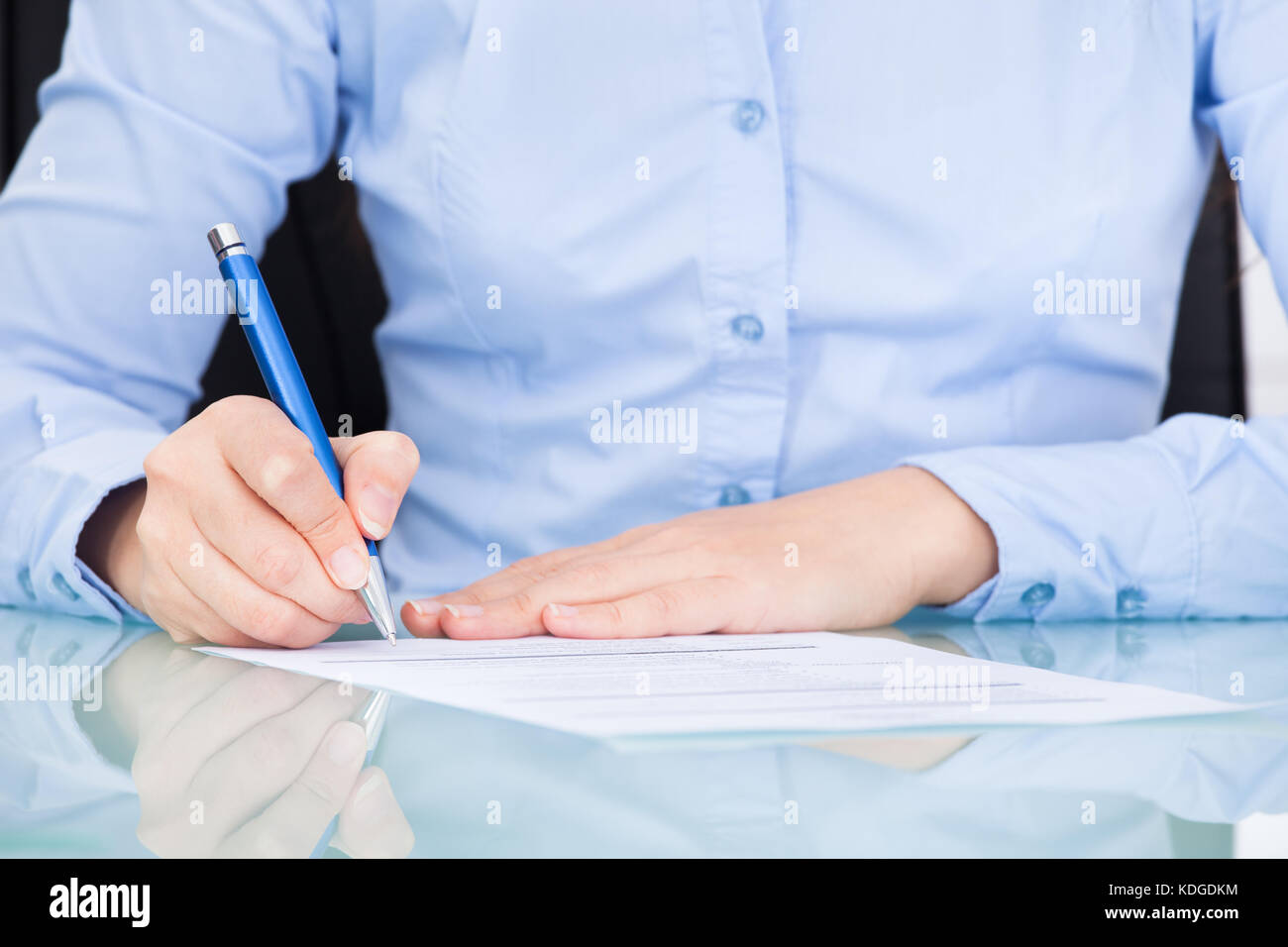 Professional woman signing document at desk hi-res stock photography ...