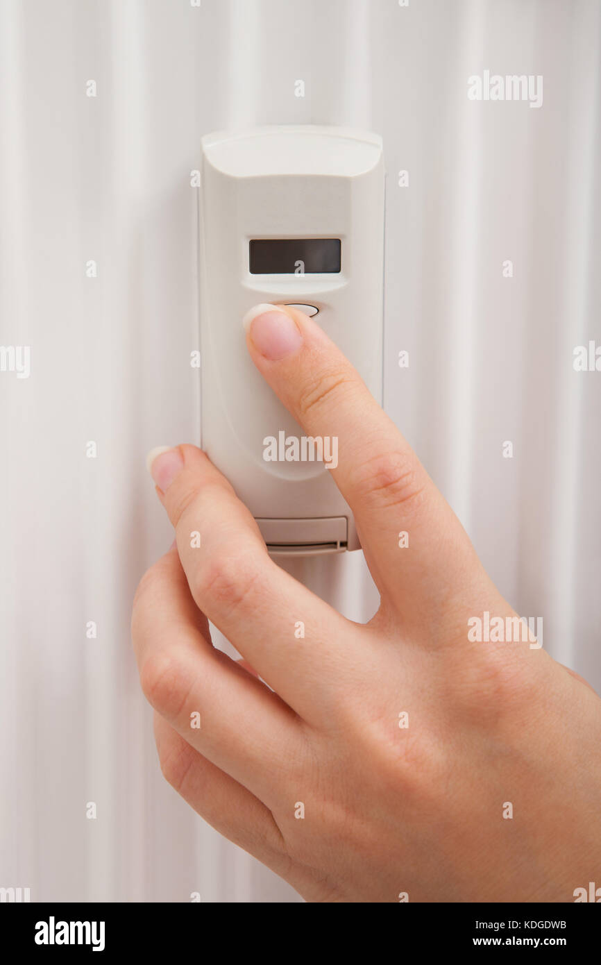 Close-up Of Person's Hand Adjusting Temperature With Digital Thermostat ...