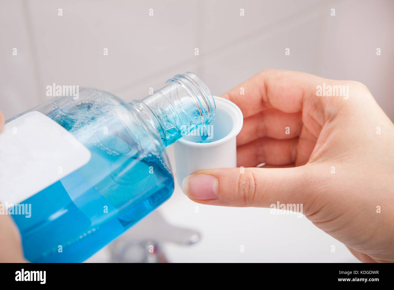 Close-up Of Person's Hand Pouring Liquid In Container Stock Photo - Alamy