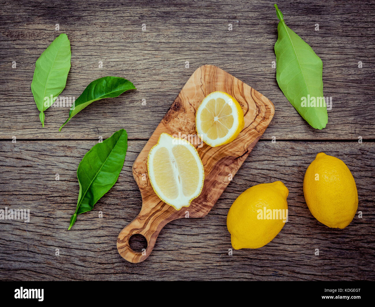 Fresh lemons and lemons leaves on rustic wooden background. Fresh ...