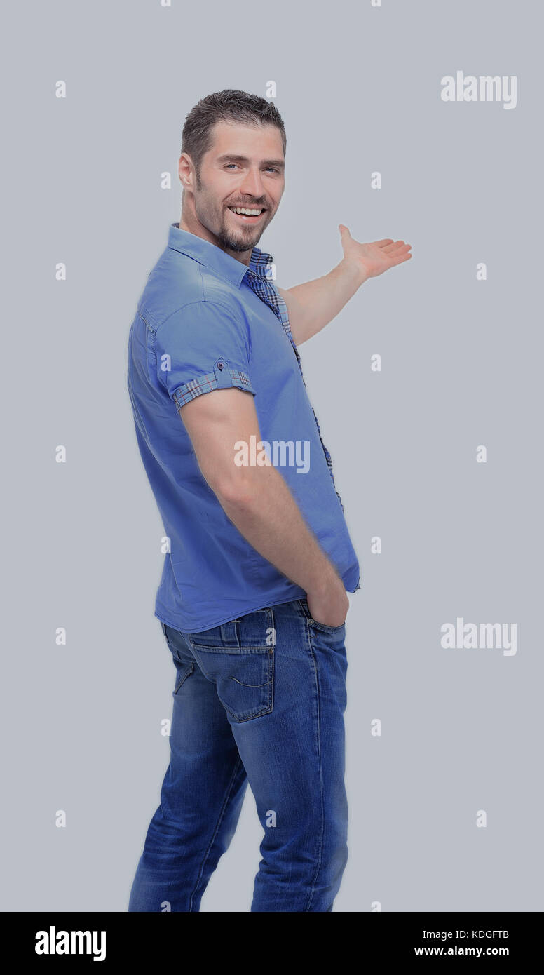 Happy smiling young man presenting and showing your text or product ...