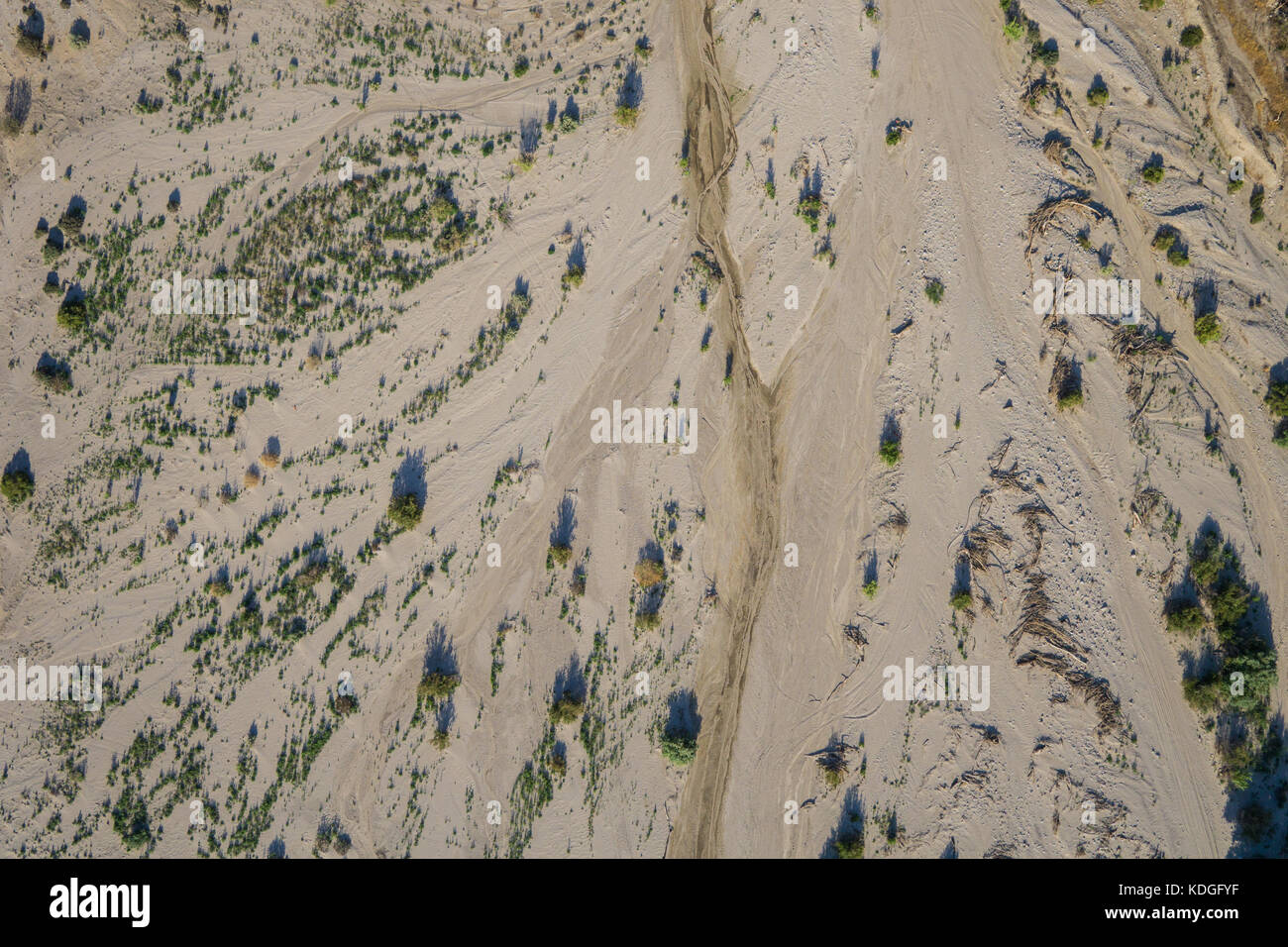 Sand desert on the bottom of a dry creek bed in the southwest United ...