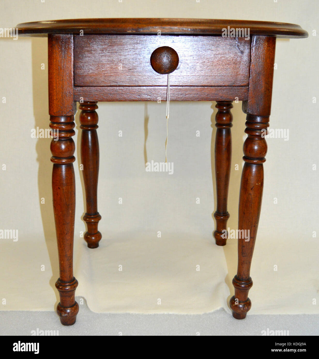 A miniature table, likely crafted for display or collection purposes ...