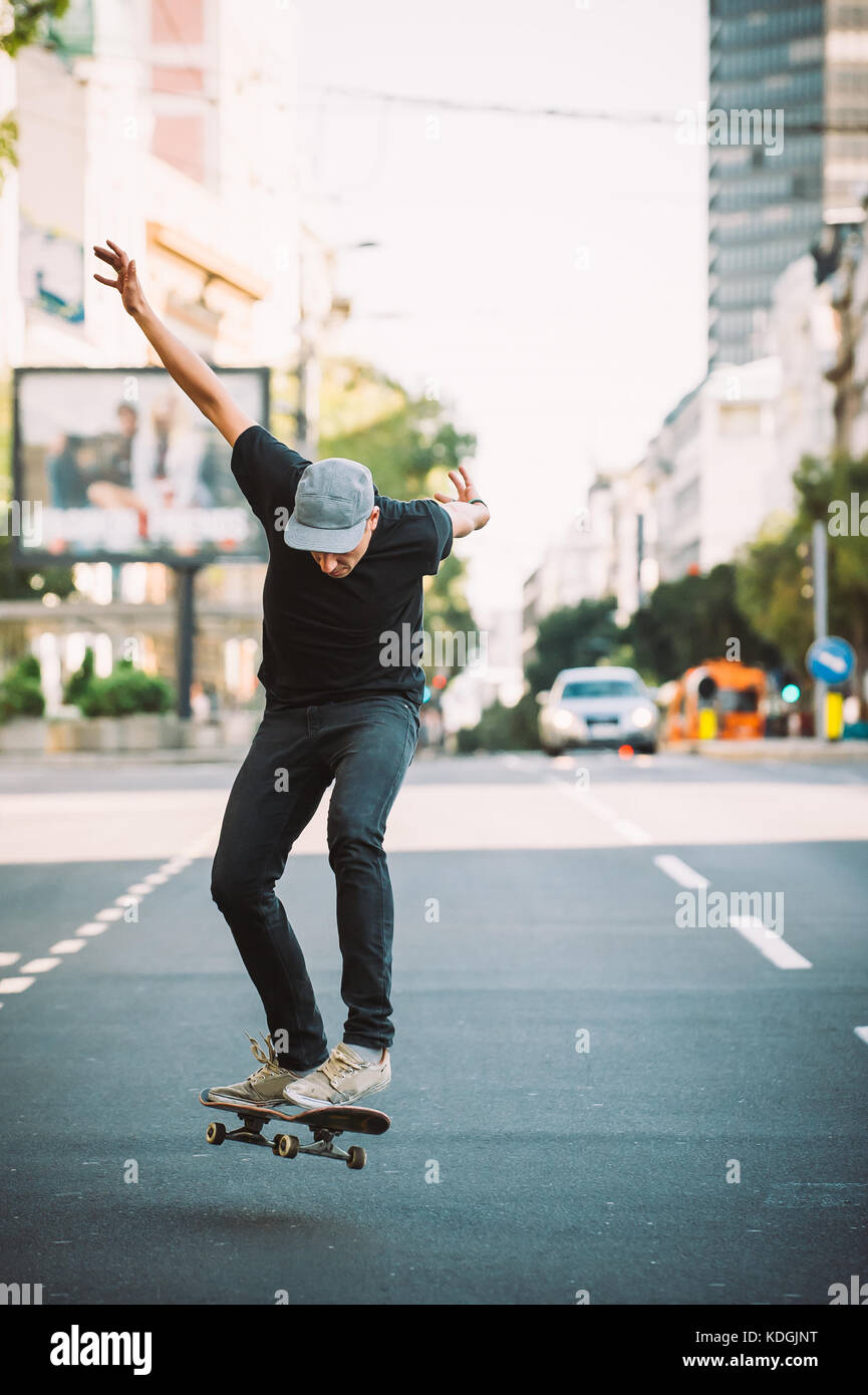 Pro skater riding skate, doing tricks and jumps on the main streets ...