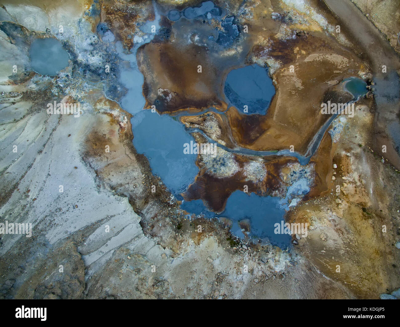 Aerial view of a geothermal hotspot in Iceland, blue mudpools with red ...