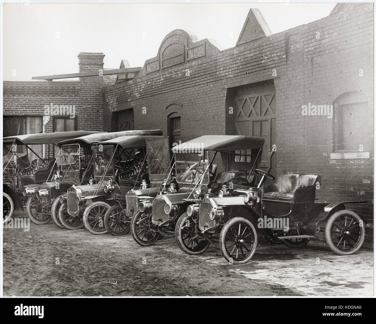 Line of 1910 era automobiles parked in front of the old City Garage ...