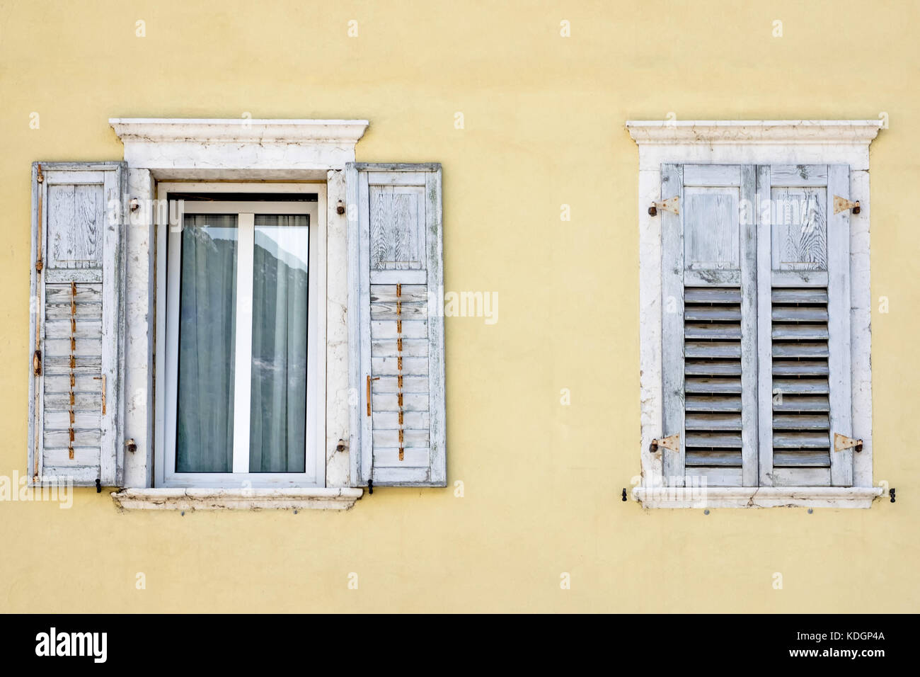 Two windows with window shutters in a yellow house Stock Photo - Alamy