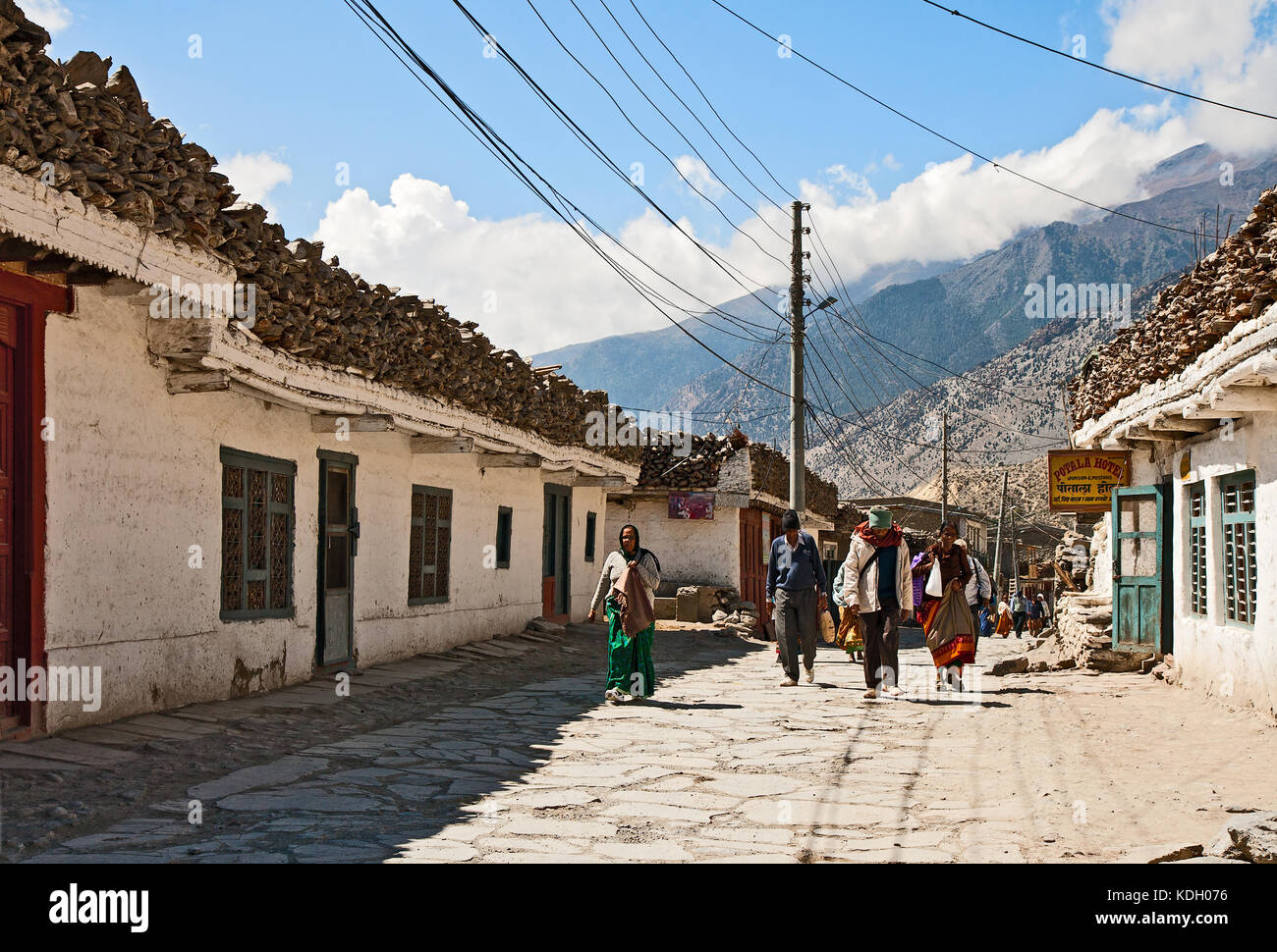 JOMSOM, NEPAL - OCTOBER 02, 2012 - The locals go along the only street ...