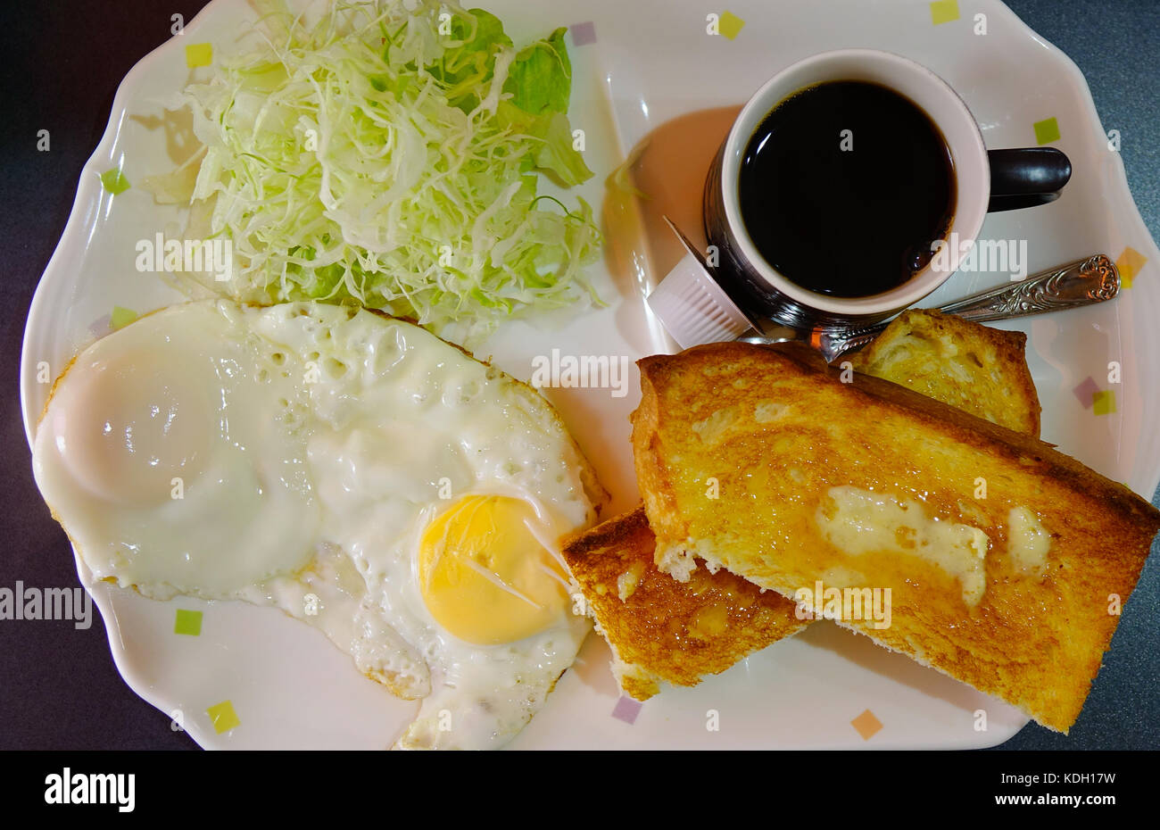 Western breakfast with coffee, bread, eggs and vegetable. Close up ...