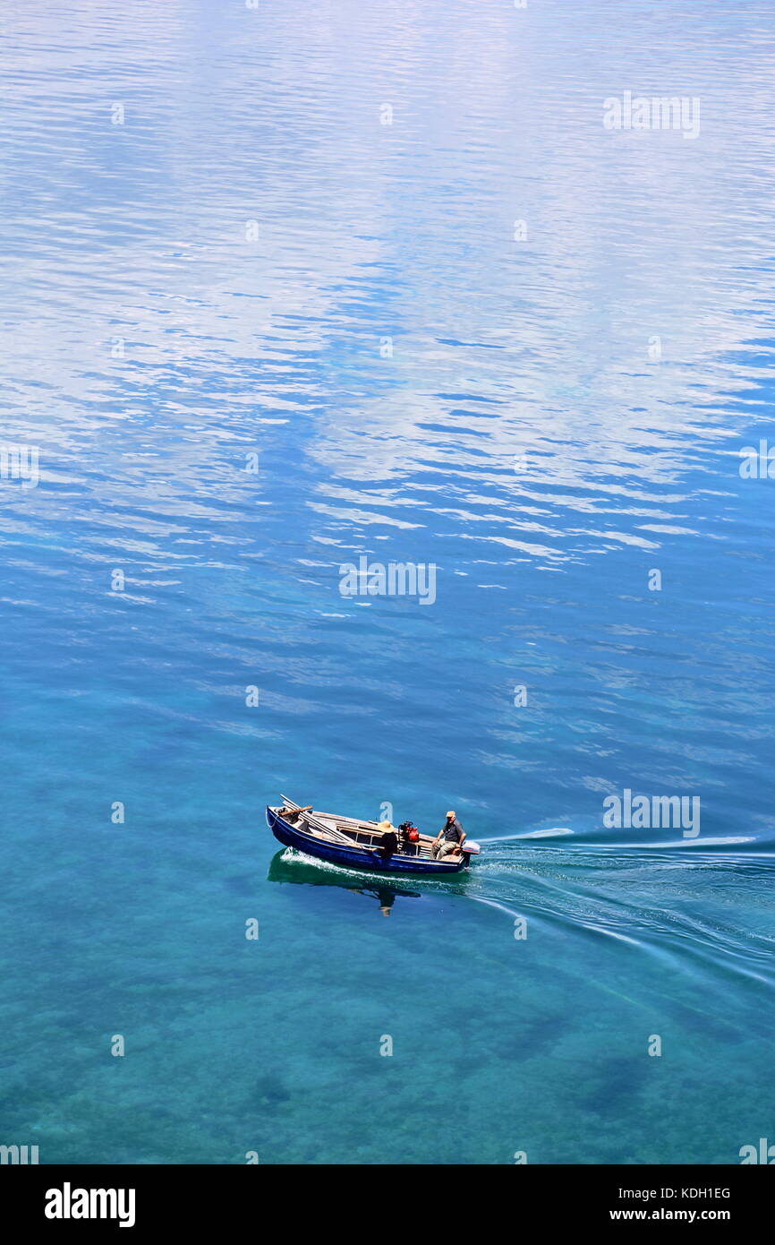 Fishing boat at clear waters of Lake Ohrid surrounding Lin Peninsula in ...