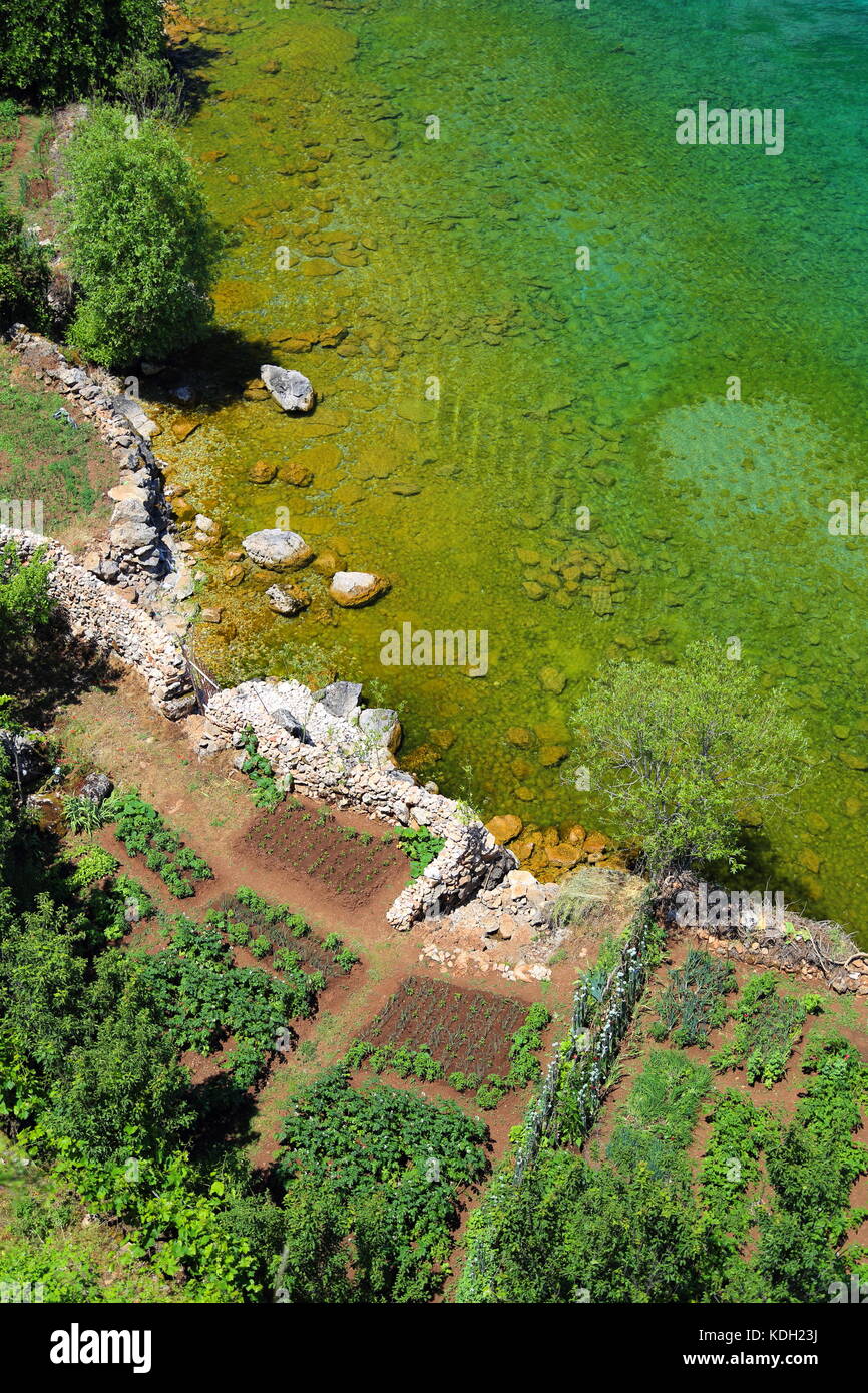 Clear waters and lake shore gardens that represent traditional land use ...