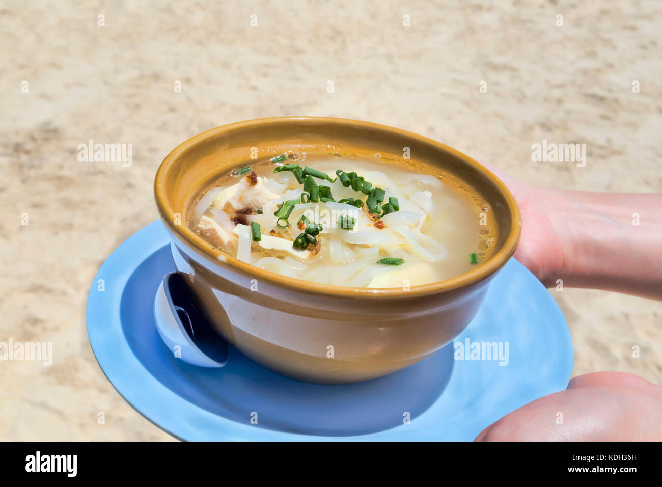 Thai chicken noodle soup on the beach - selective focus Stock Photo - Alamy