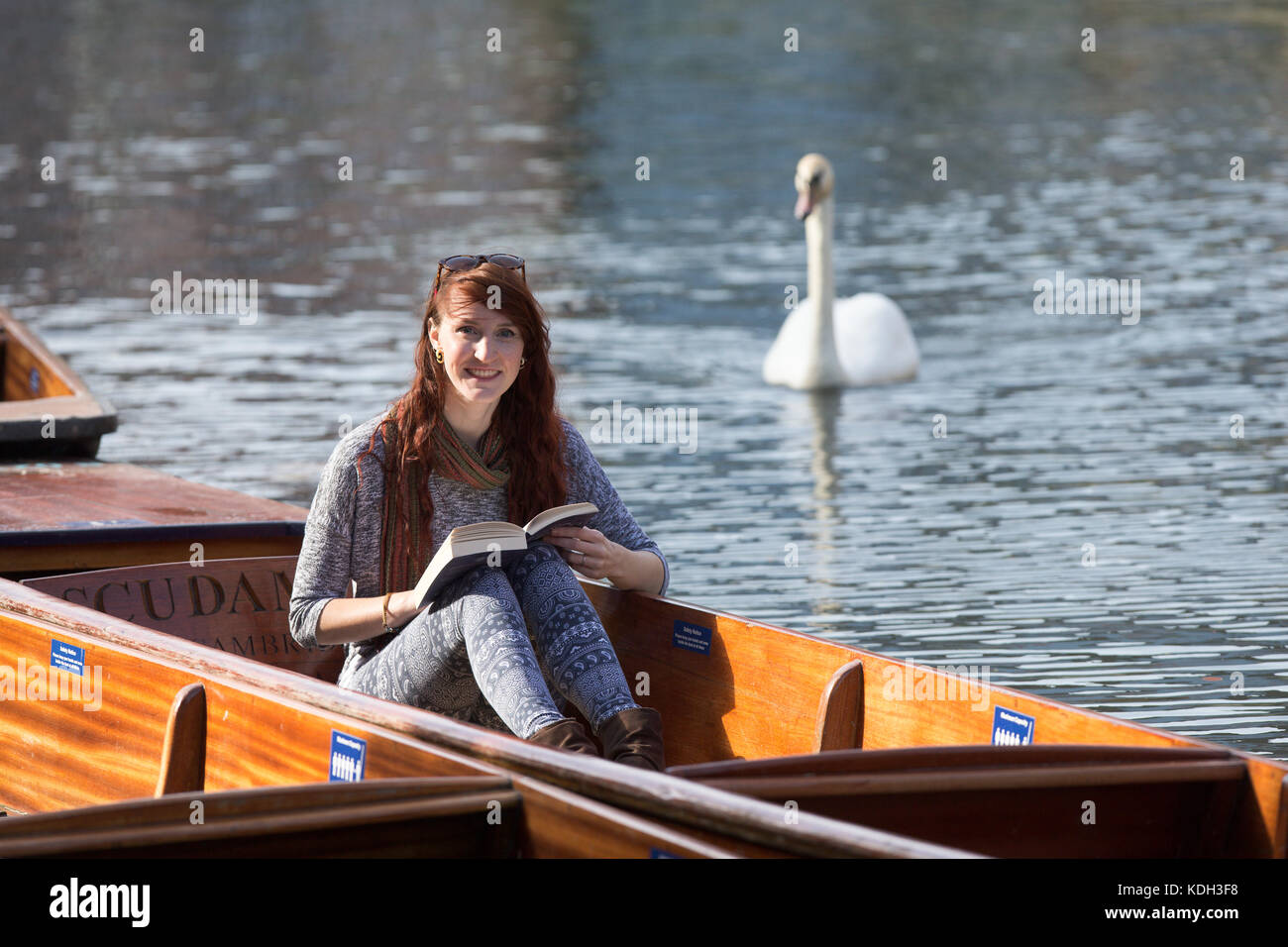 Cambridge University student Jess Shaw sitting on a punt reading a boo ...