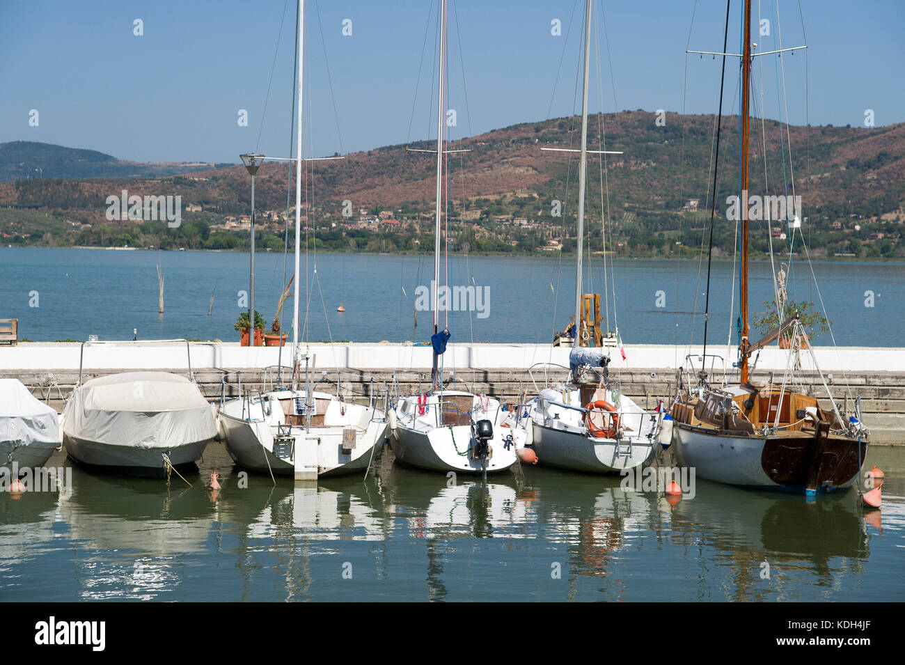 Sailing boats in small marina by Lago Trasimeno (Lake Trasimeno) in ...